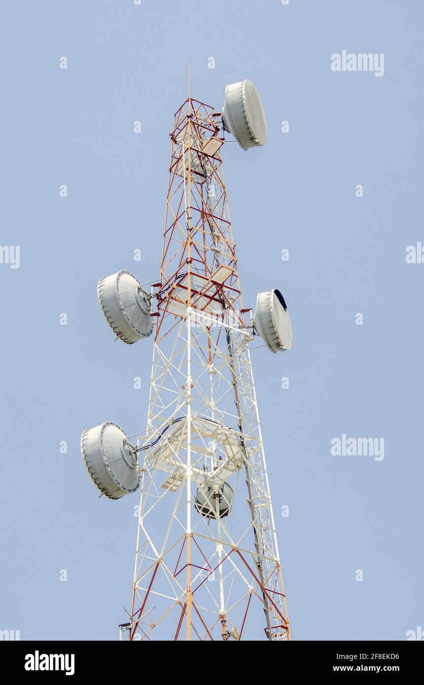 Vertical low angle of telecommunication tower on clean blue sky ...
