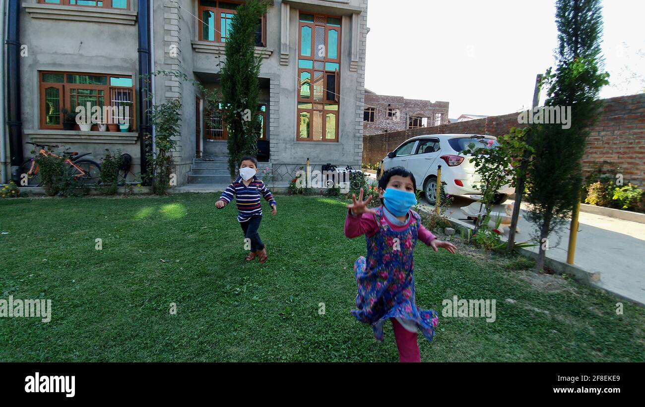 Masked kids playing Stock Photo - Alamy