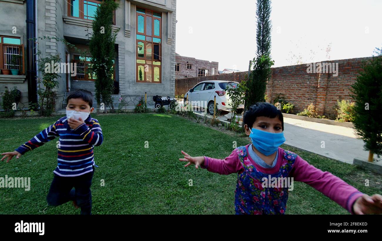 Masked kids playing Stock Photo - Alamy