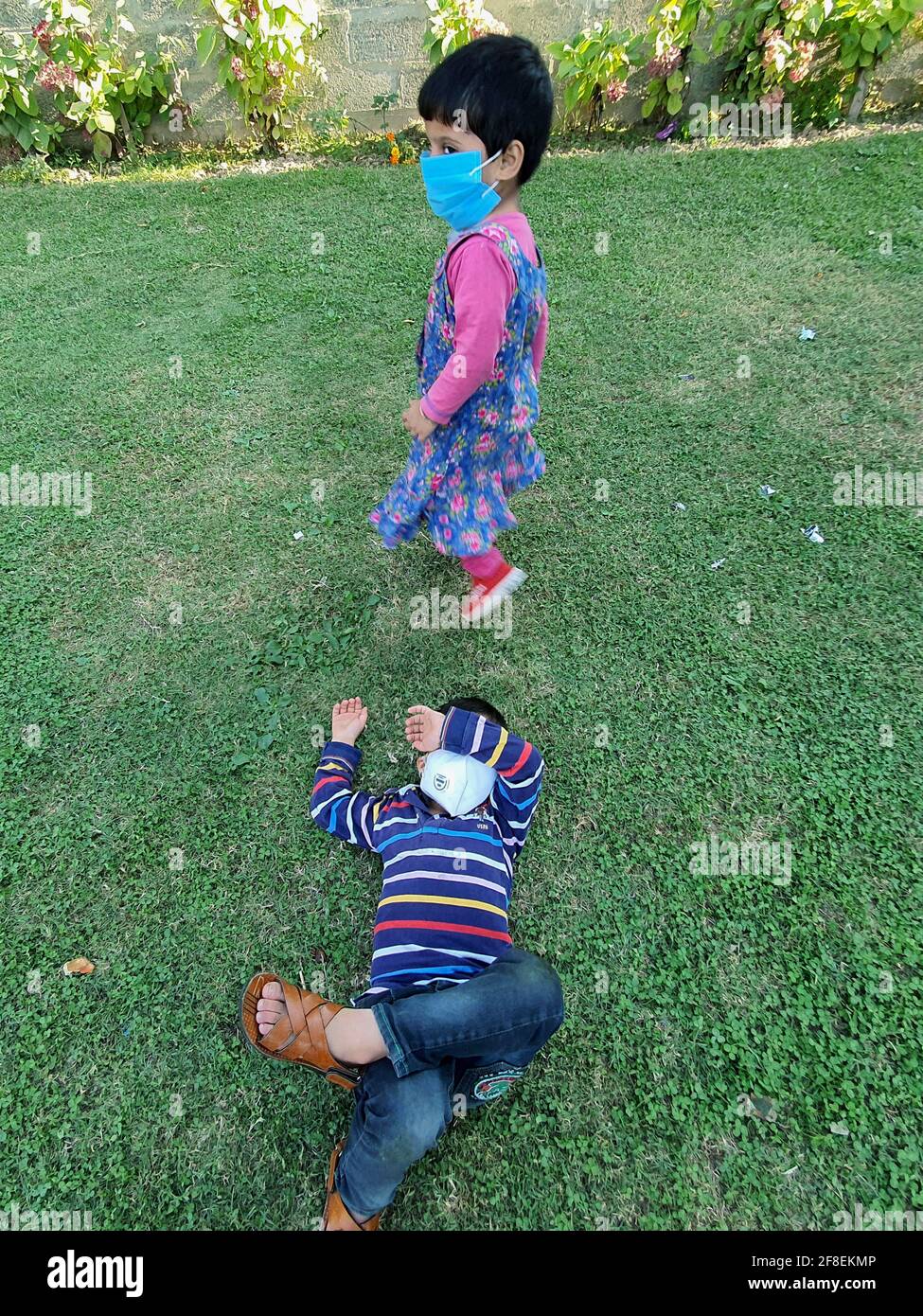 Masked kids playing Stock Photo - Alamy