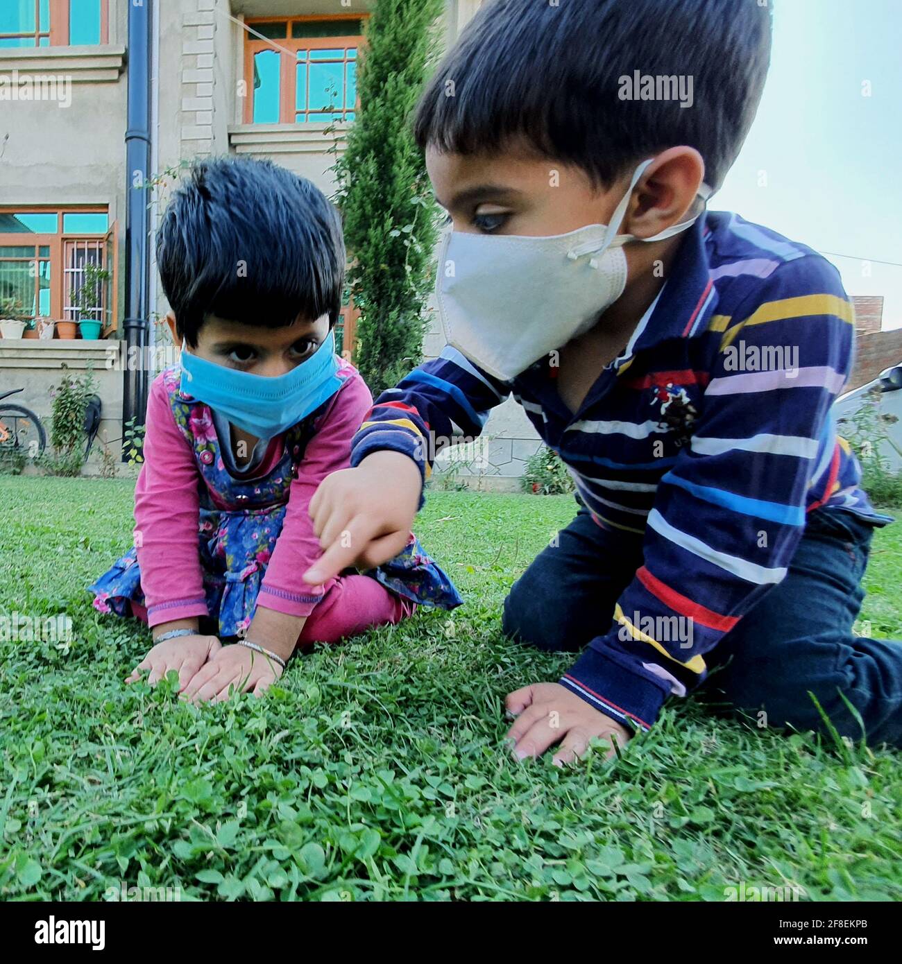 Masked kids playing Stock Photo - Alamy