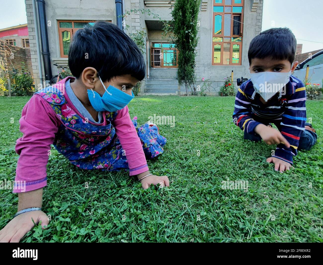 Masked kids playing Stock Photo - Alamy