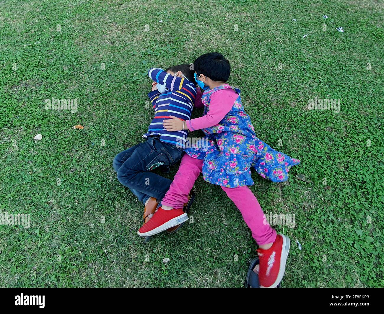 Masked kids playing Stock Photo - Alamy