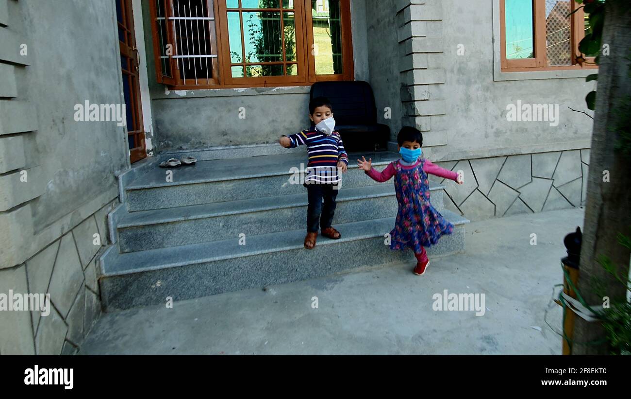 Masked kids playing Stock Photo - Alamy