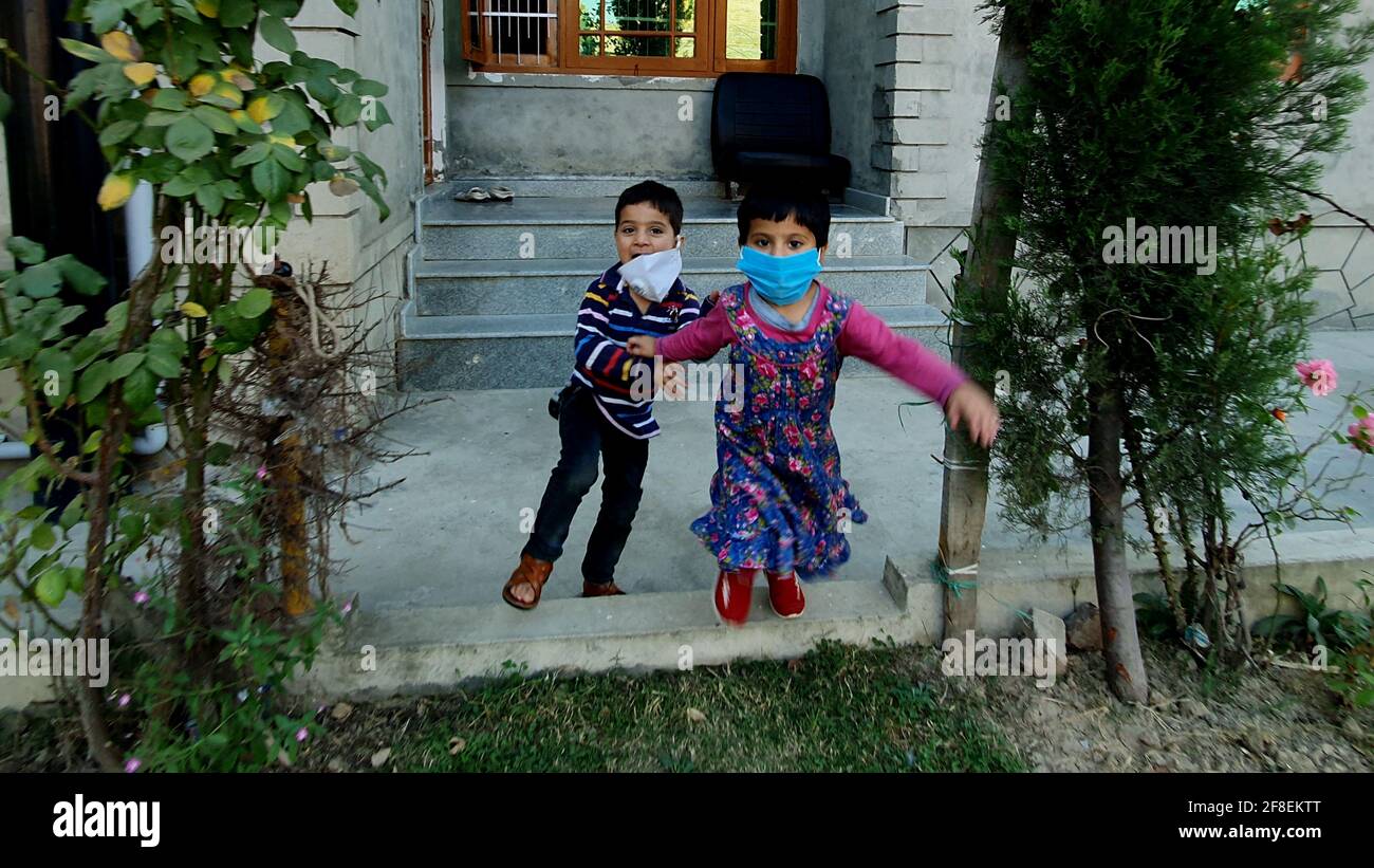 Masked kids playing Stock Photo - Alamy