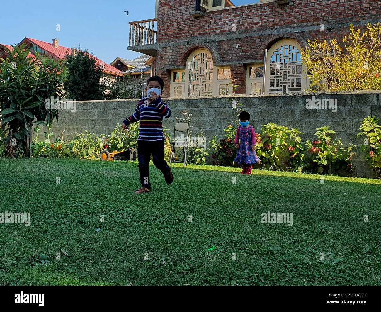 Masked kids playing Stock Photo - Alamy