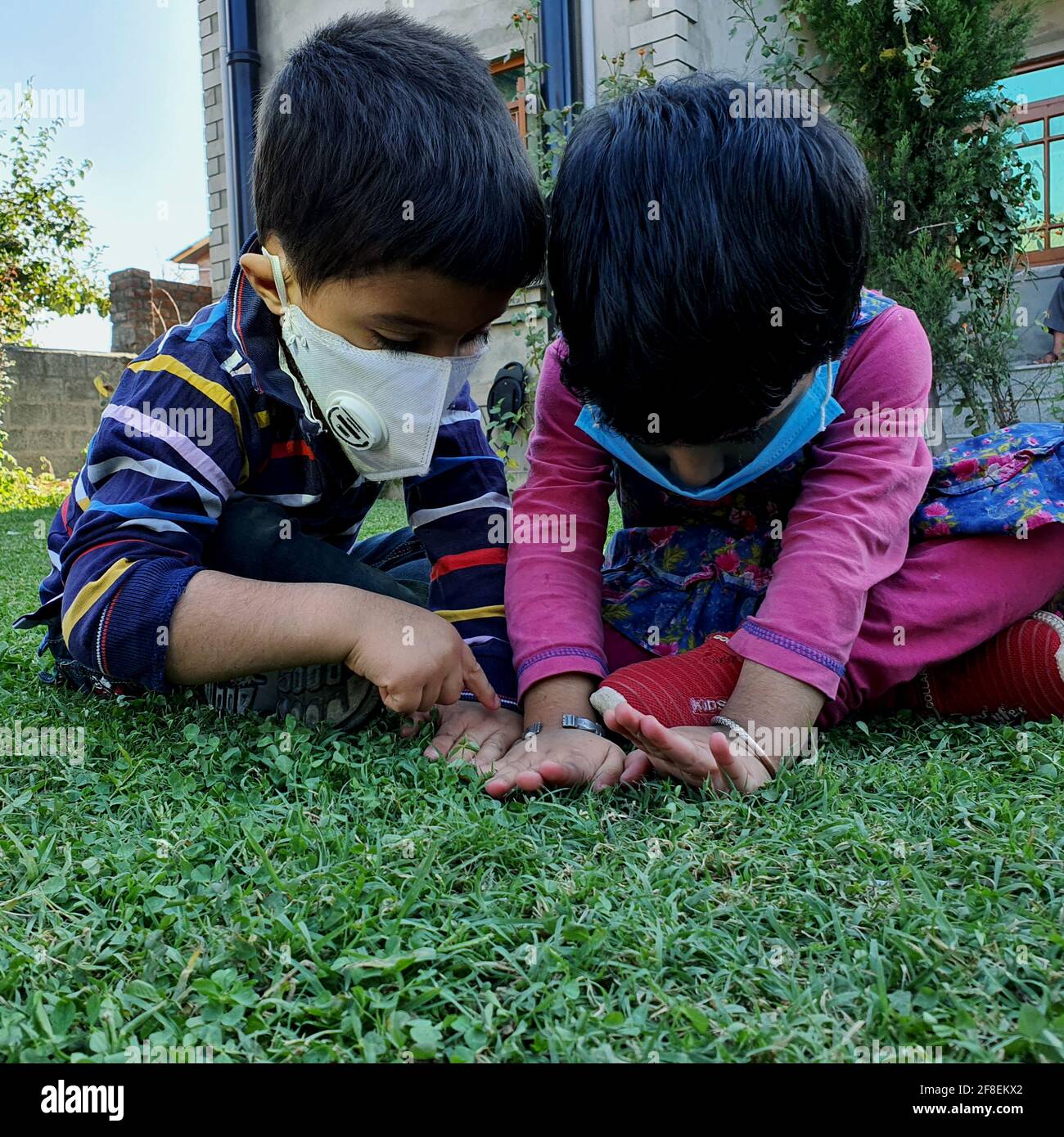 Masked kids playing Stock Photo - Alamy