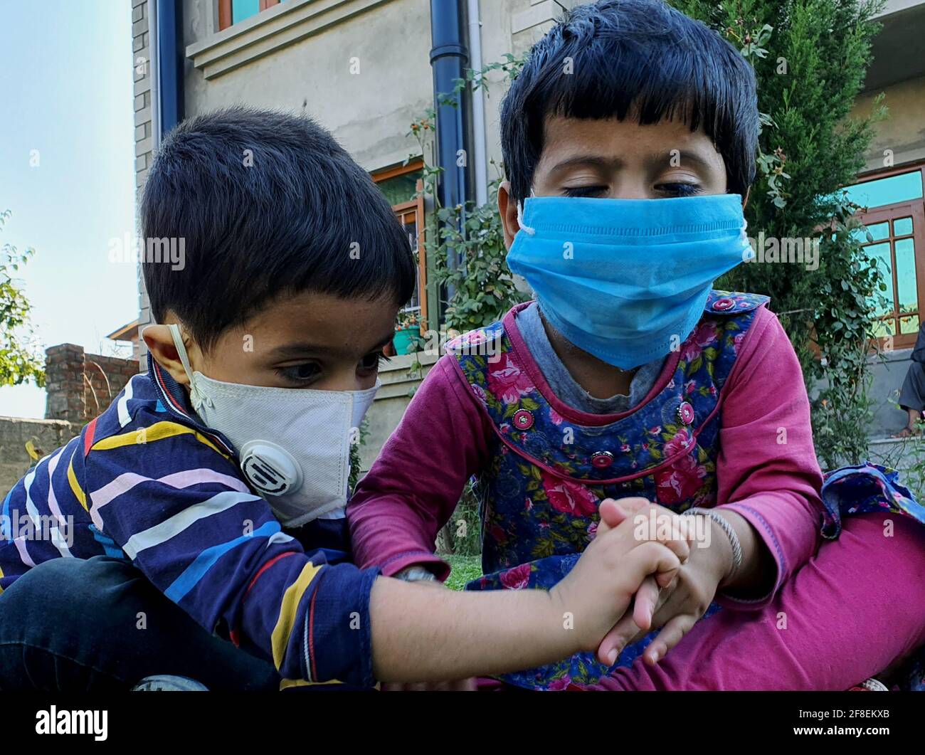 Masked kids playing Stock Photo - Alamy