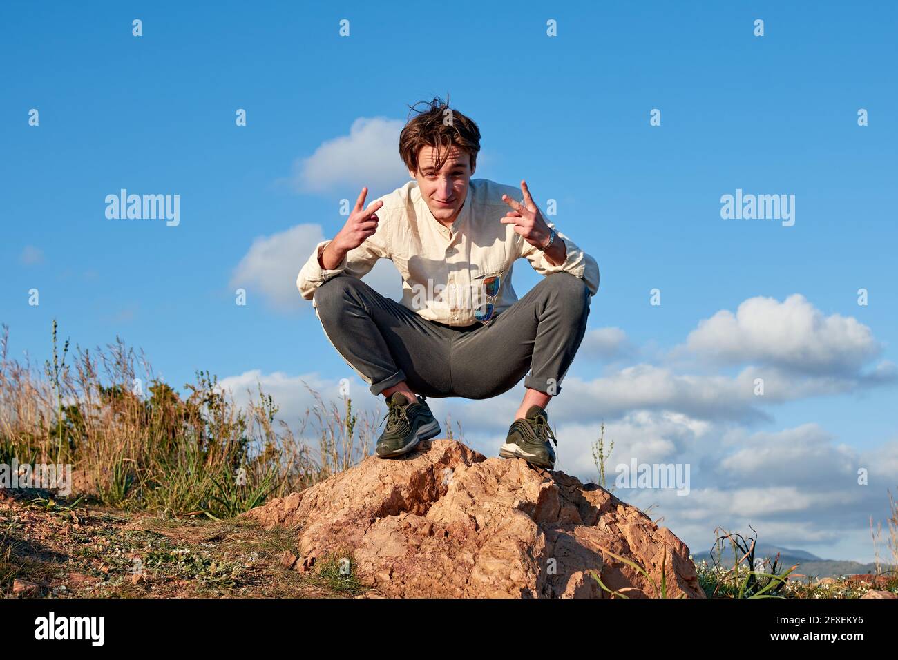 Caucasian man from Spain making a peace sign with both hands while ...