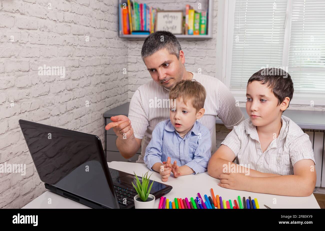 Father working from home, having a work video call, sons playing Stock ...