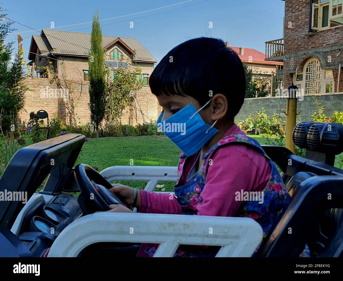 Masked kids playing Stock Photo - Alamy