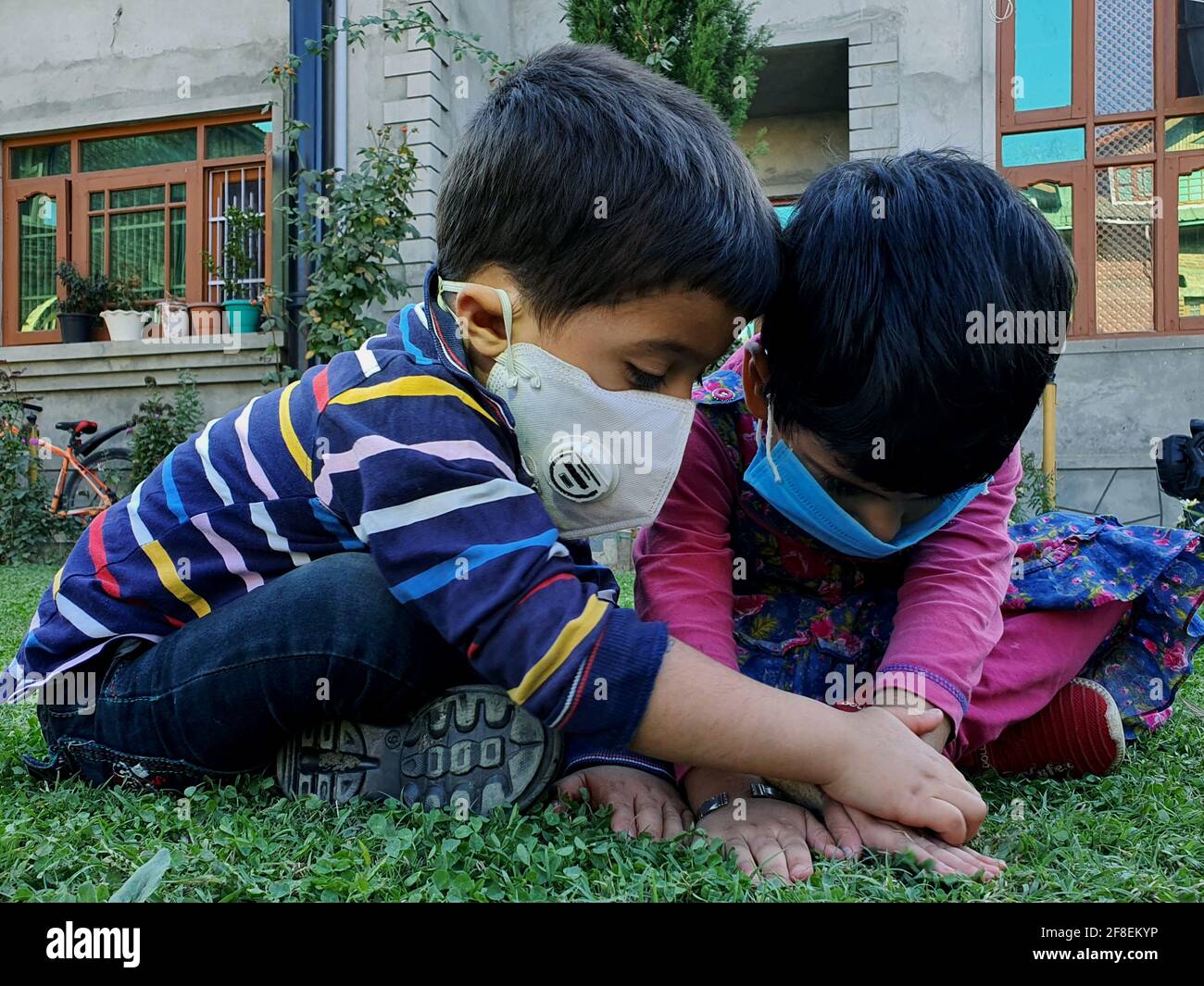 Masked kids playing Stock Photo - Alamy