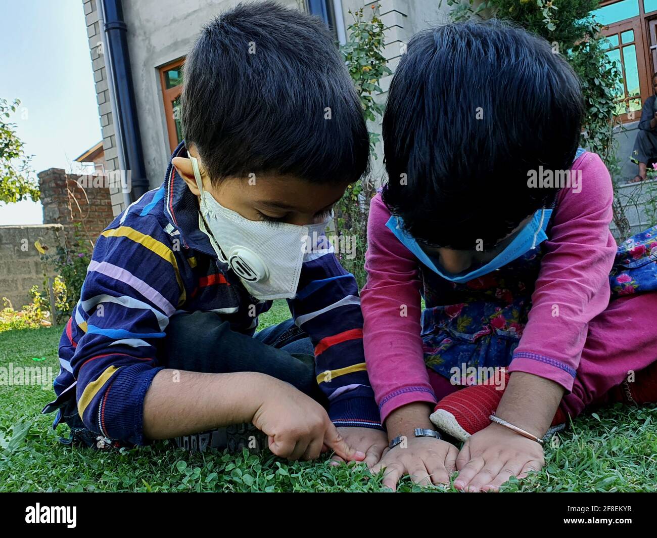 Masked kids playing Stock Photo - Alamy