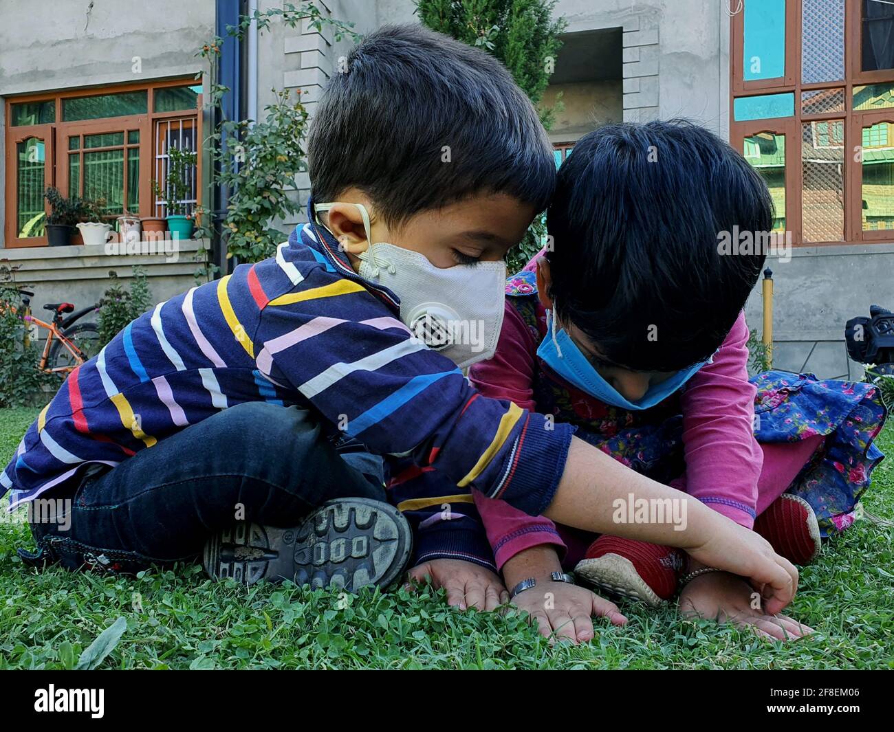 Masked kids playing Stock Photo - Alamy