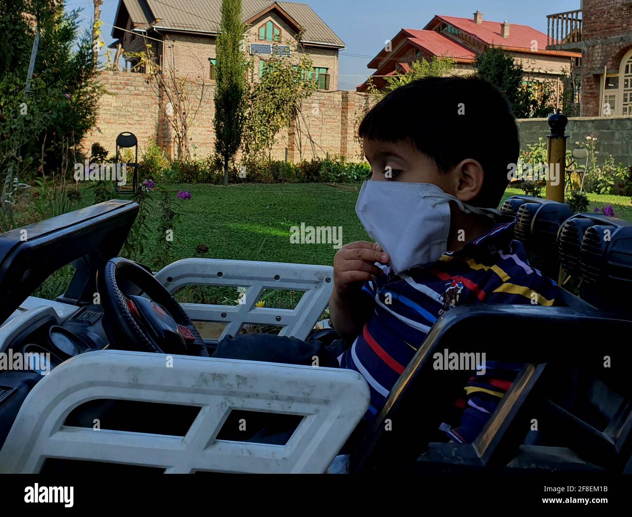 Masked kids playing Stock Photo - Alamy