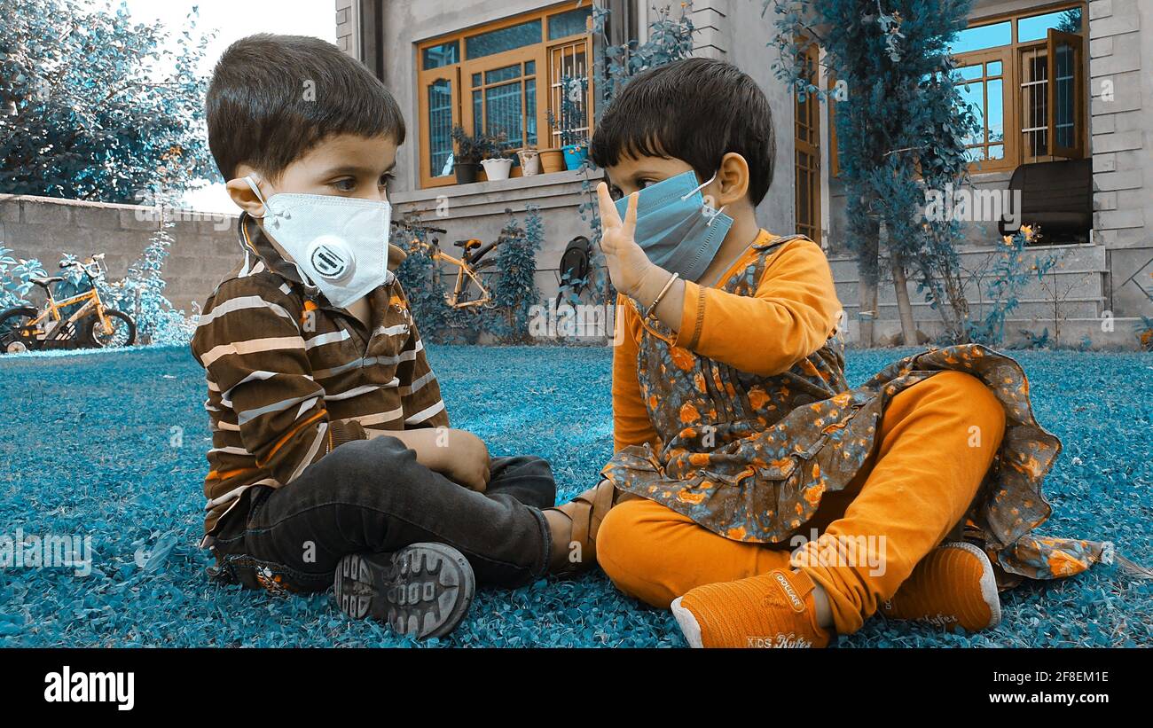 Masked kids playing Stock Photo - Alamy