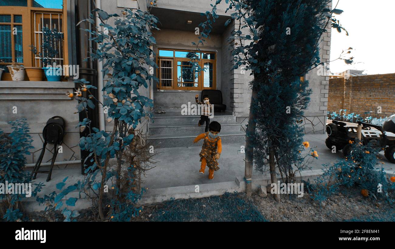 Masked kids playing Stock Photo - Alamy