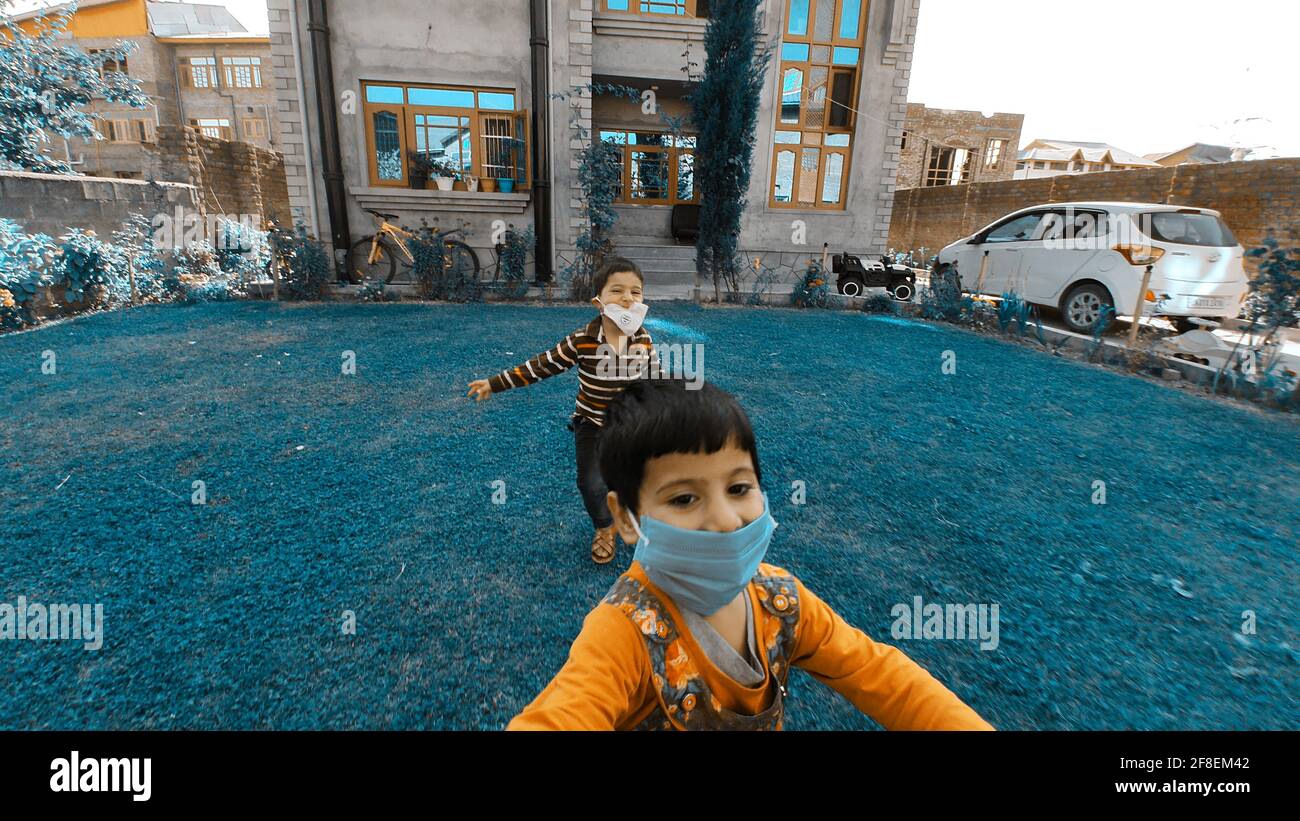 Masked kids playing Stock Photo - Alamy