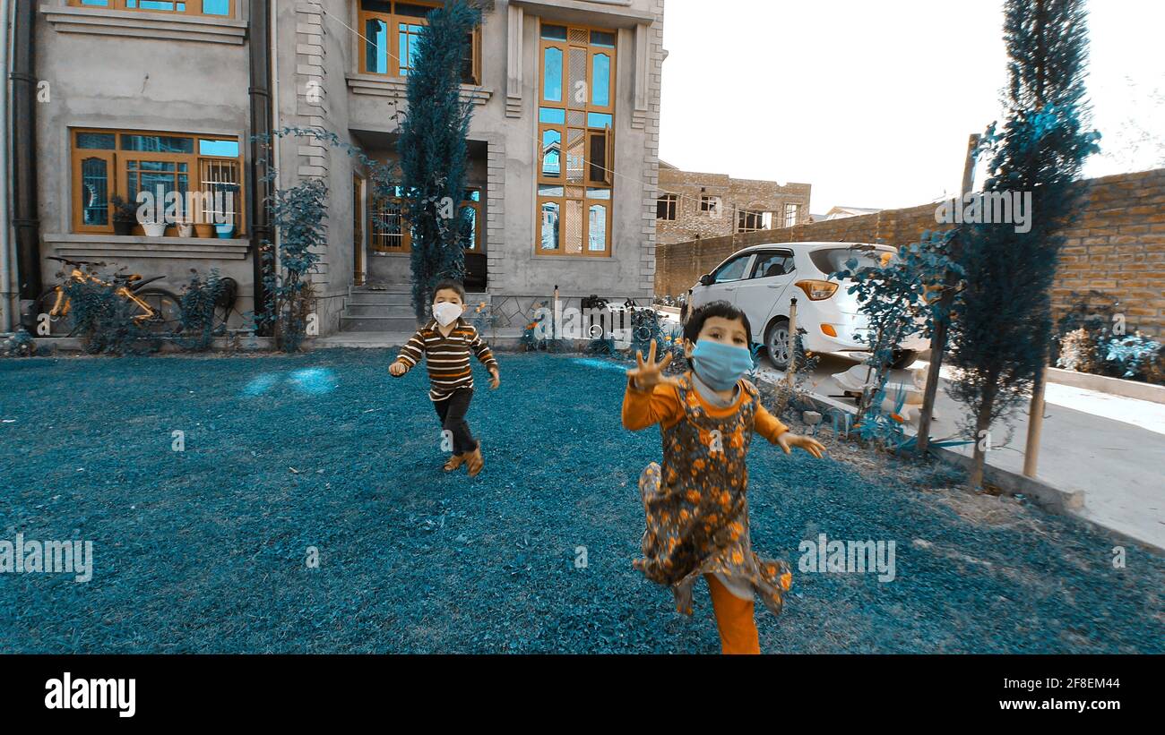 Masked kids playing Stock Photo - Alamy