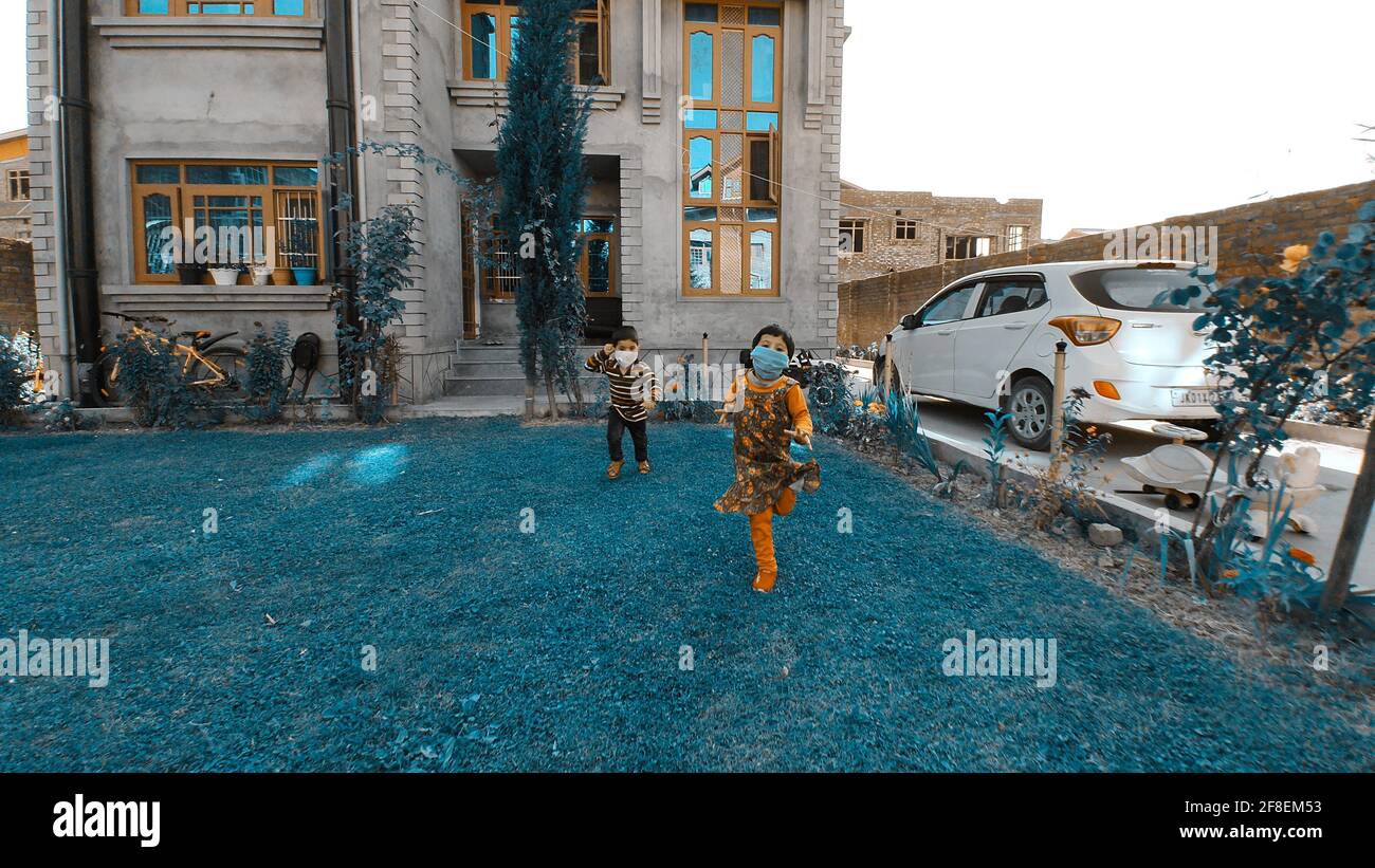 Masked kids playing Stock Photo - Alamy