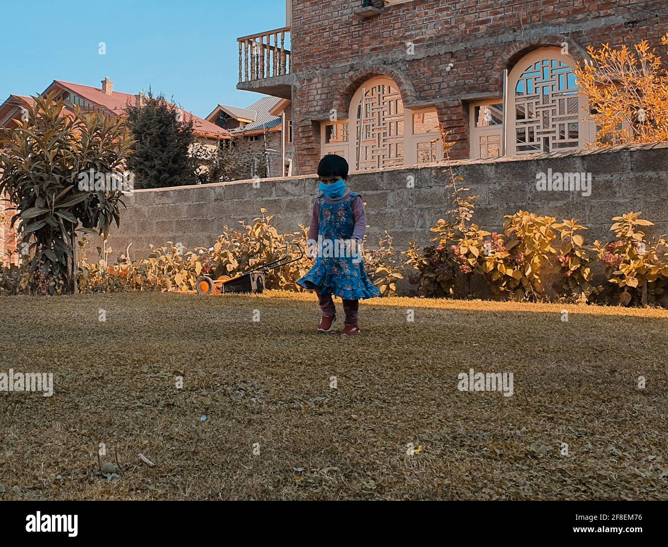 Masked kids playing Stock Photo - Alamy