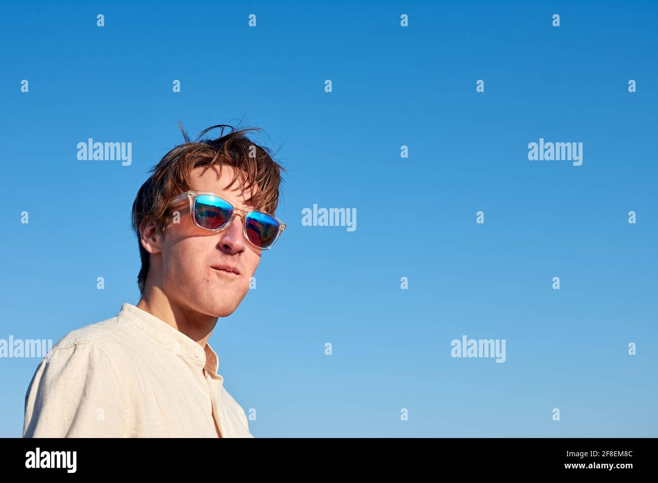 Shallow focus of a Spanish young male wearing stylish sunglasses ...