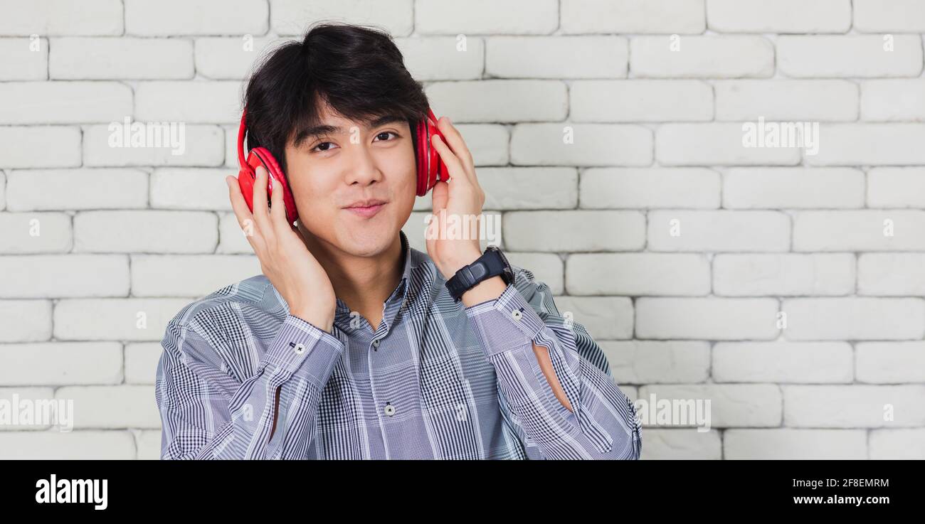 Portrait of Asian handsome young man he smile listening to music in ...