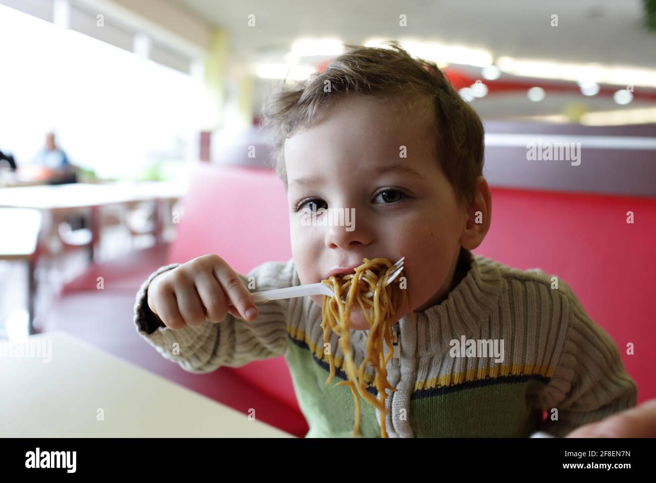 Boy eating noodles in the asian restaurant Stock Photo - Alamy