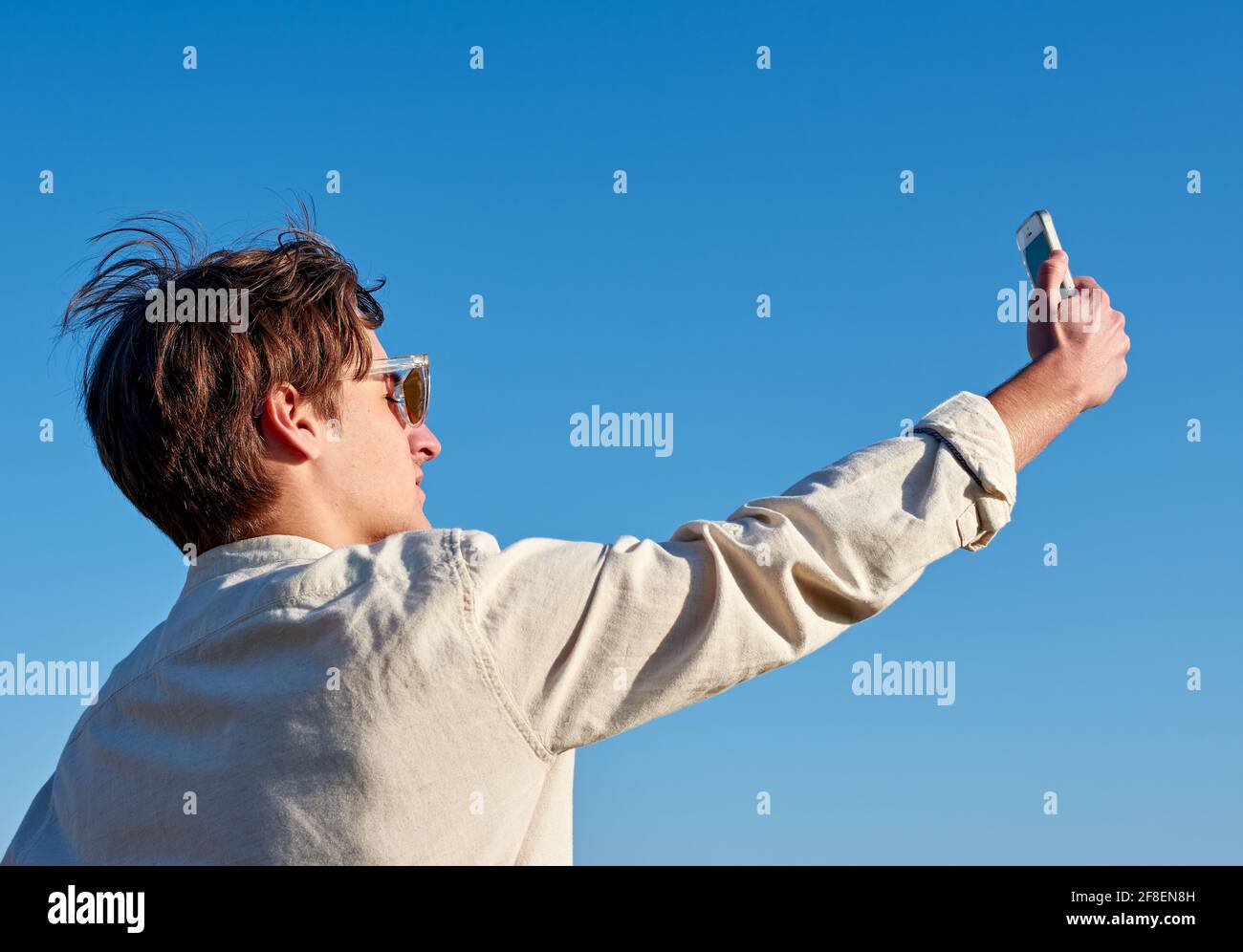 Spanish white man with glasses and a beige shirt taking a selfie on ...