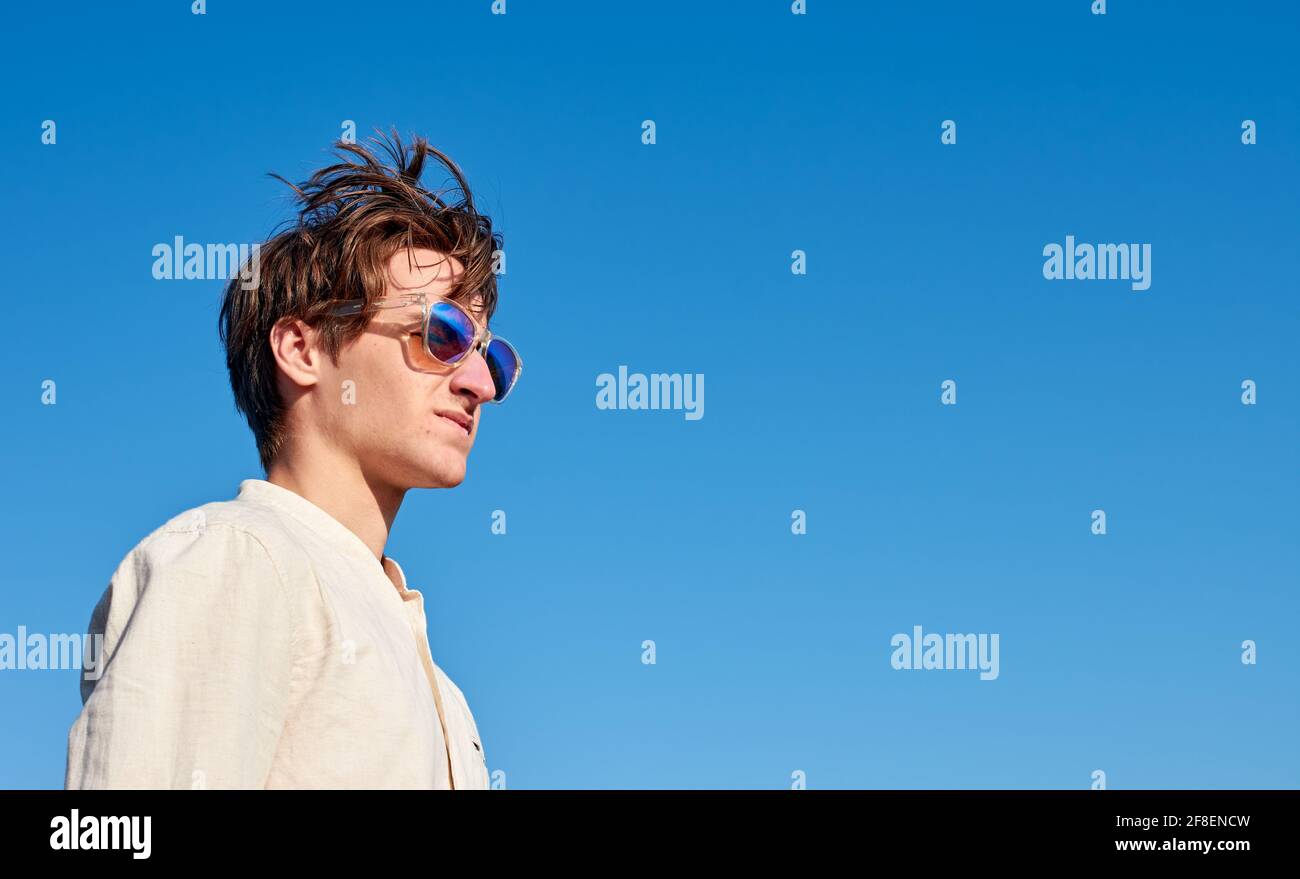 Spanish white man with purple glasses and a beige shirt glaring to the ...