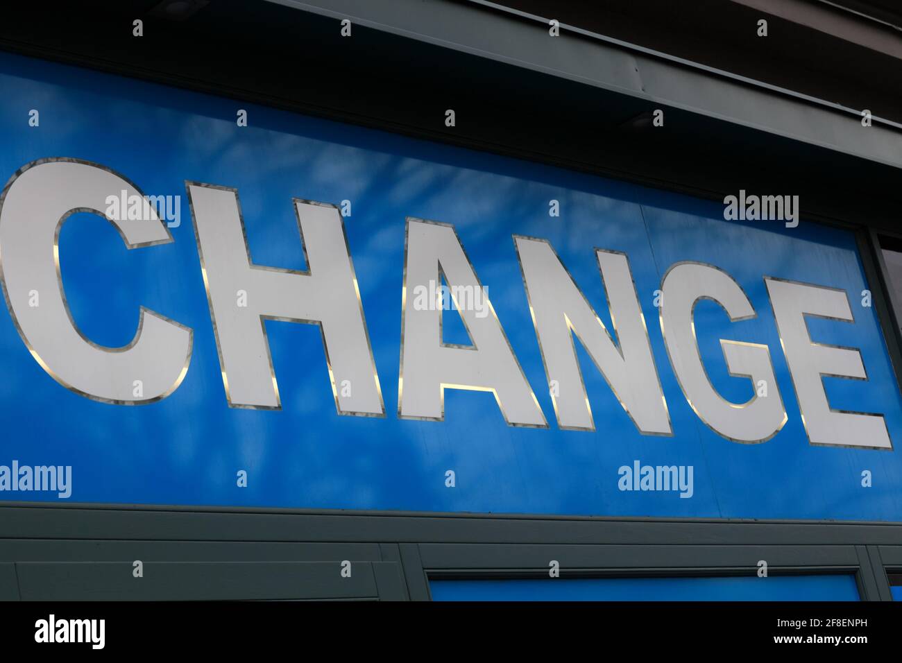 Change signboard on the wall of a building Stock Photo - Alamy