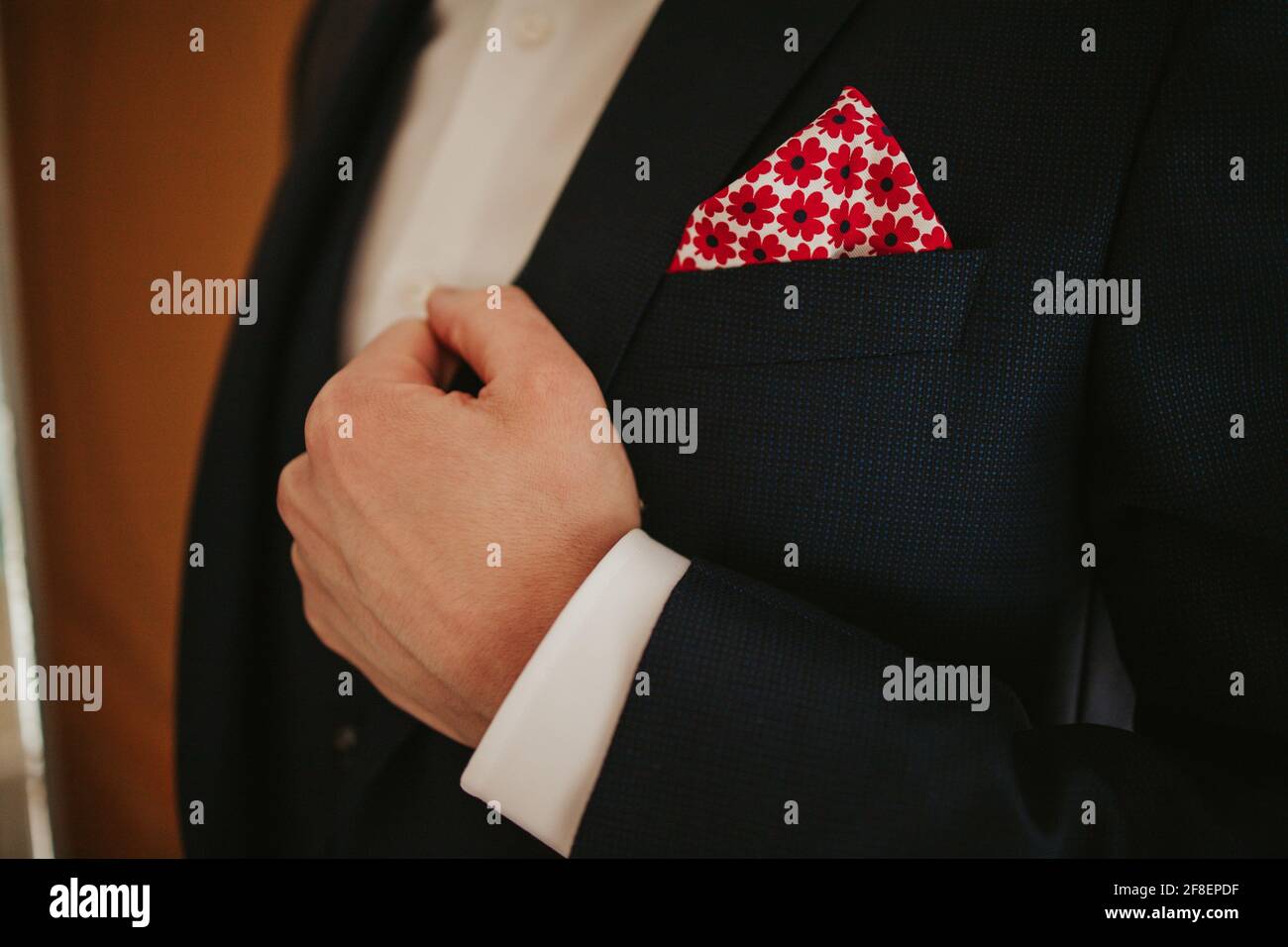 Closeup shot of the pocket square with a red handkerchief on the suit ...