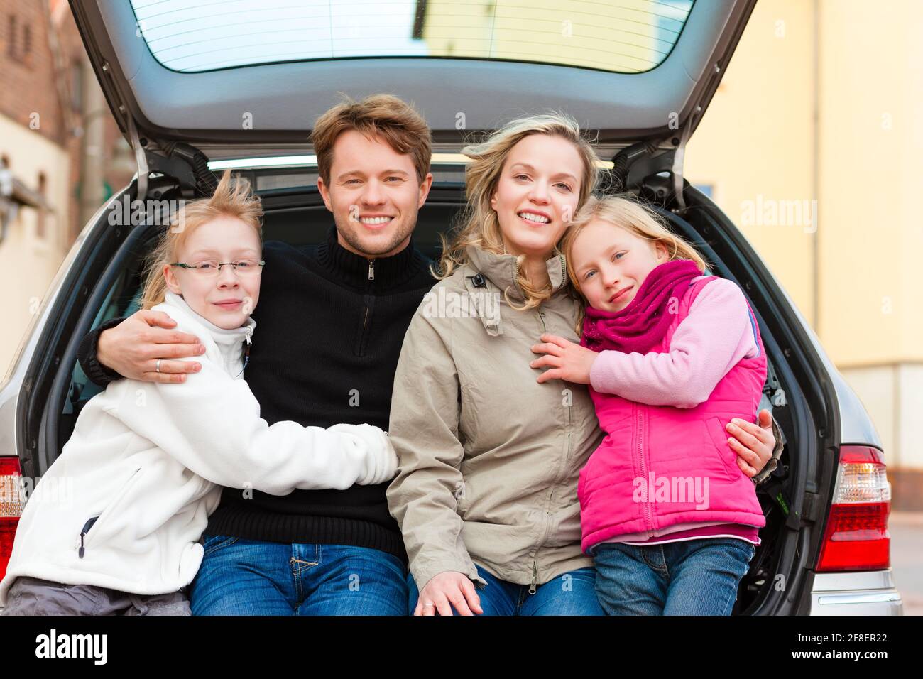 Family, mother, father and children, sitting in the trunk, they make a ...
