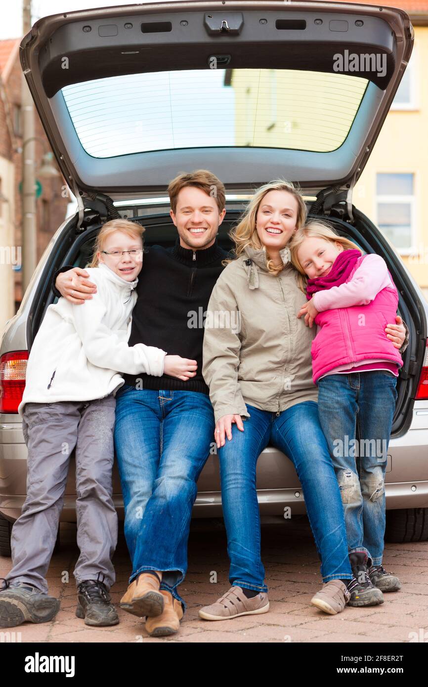 Family, mother, father and children, sitting in the trunk, they make a ...