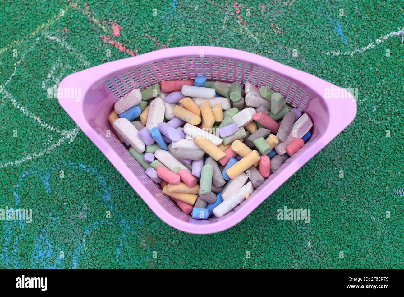The crayons in the box on the green pavement Stock Photo - Alamy