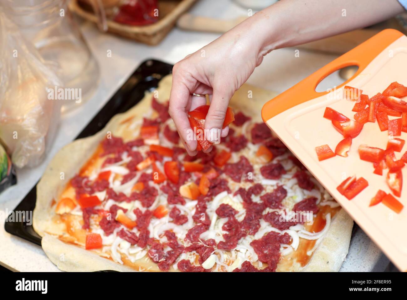 Woman putting tasty homemade pizza hi-res stock photography and images ...