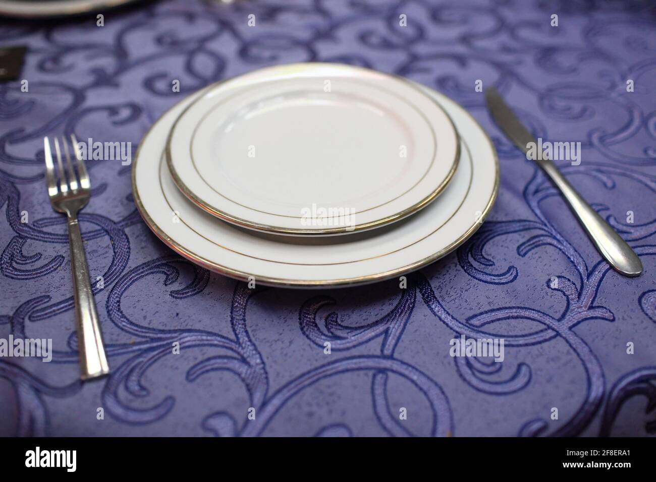The plates and cutlery on the dinning table Stock Photo - Alamy