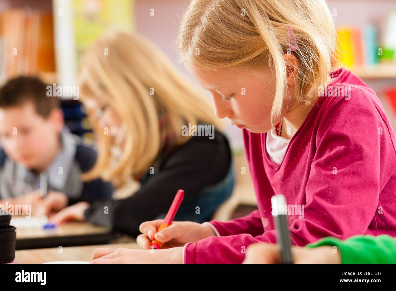 Education - Pupils at primary or elementary school doing their homework ...