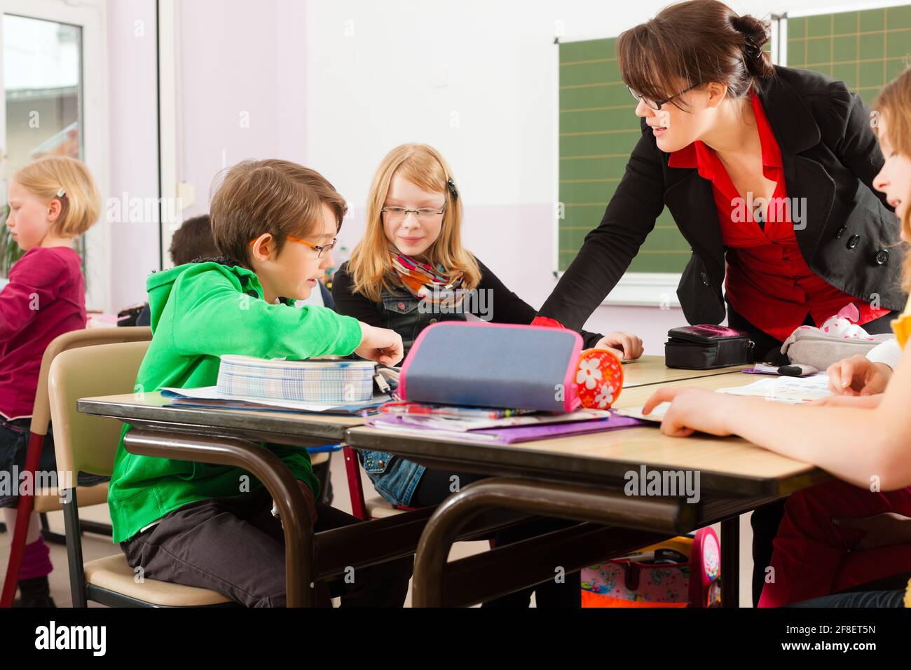 Education - Pupils and teacher learning at elementary or primary school ...