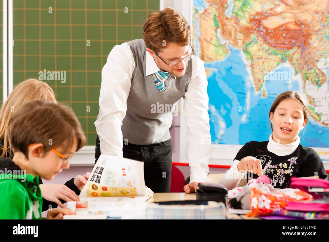 Education - Pupils and teacher learning at elementary or primary school ...