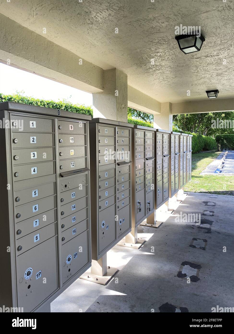 Cluster of residential mailboxes with numbered compartments for a ...