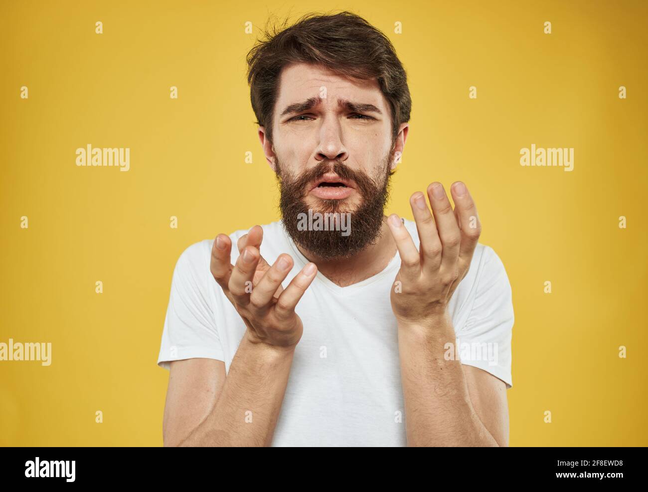 Emotions model irritability sad face yellow background man Stock Photo ...