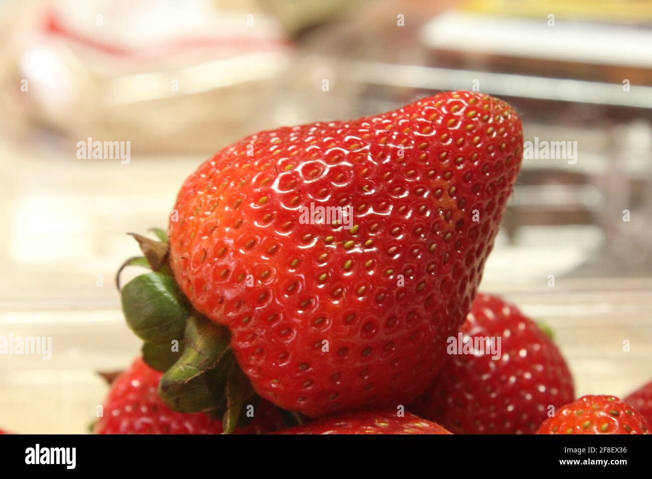 strawberries sitting on top of a table Stock Photo - Alamy