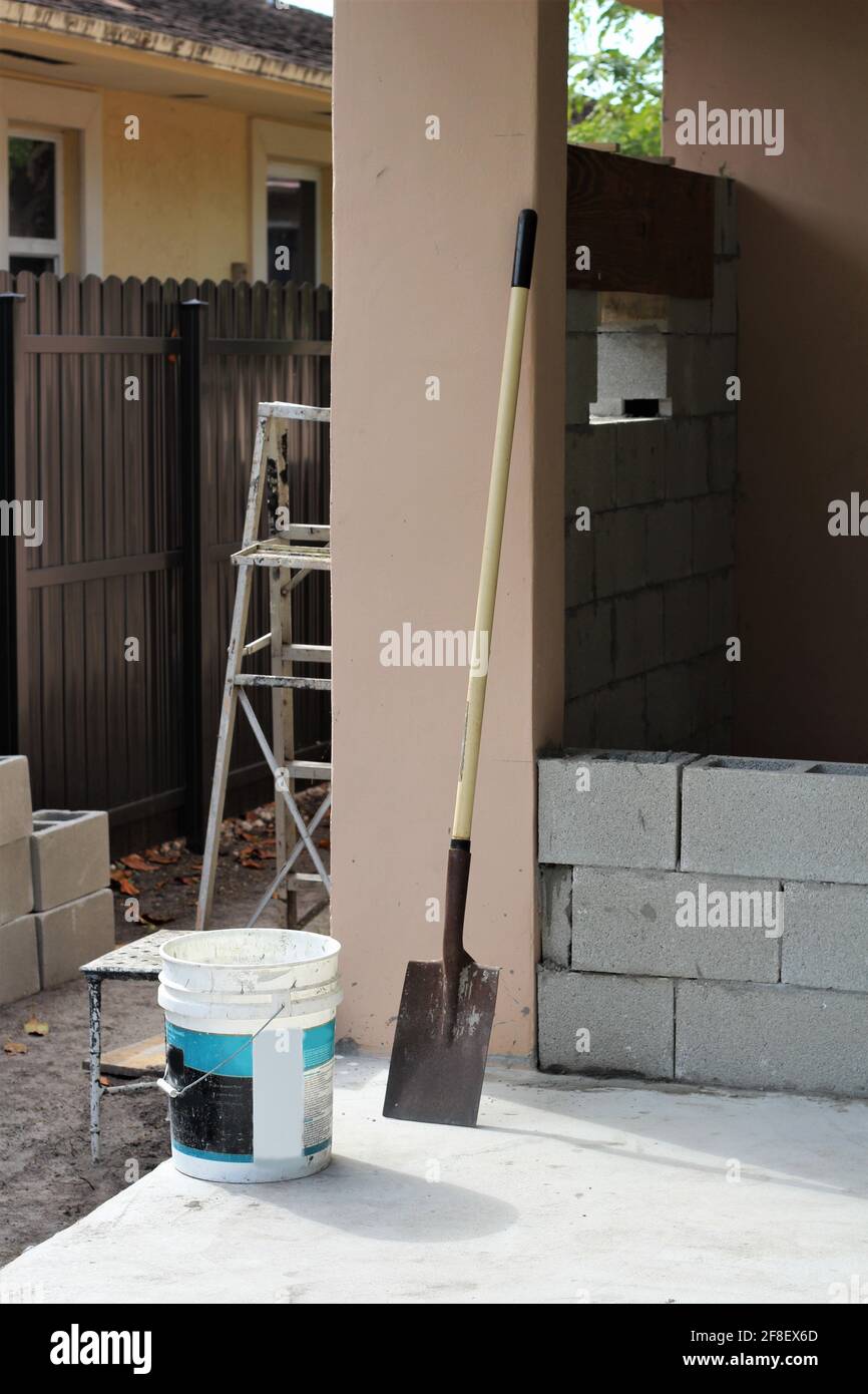 Construction work being performed in a backyard to create a tool shed ...