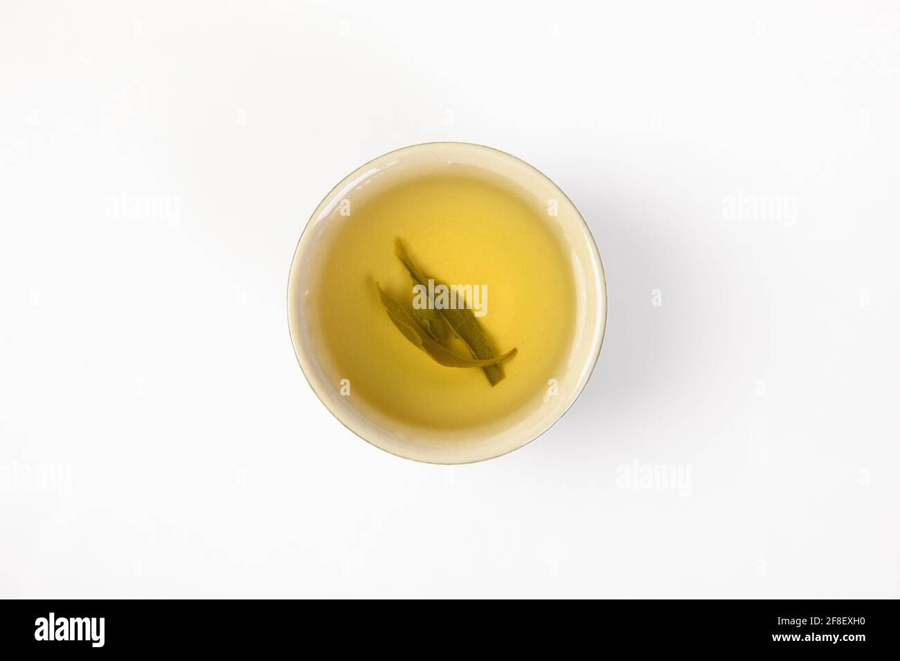 Overhead shot of fresh green tea served using a Japanese cup isolated ...