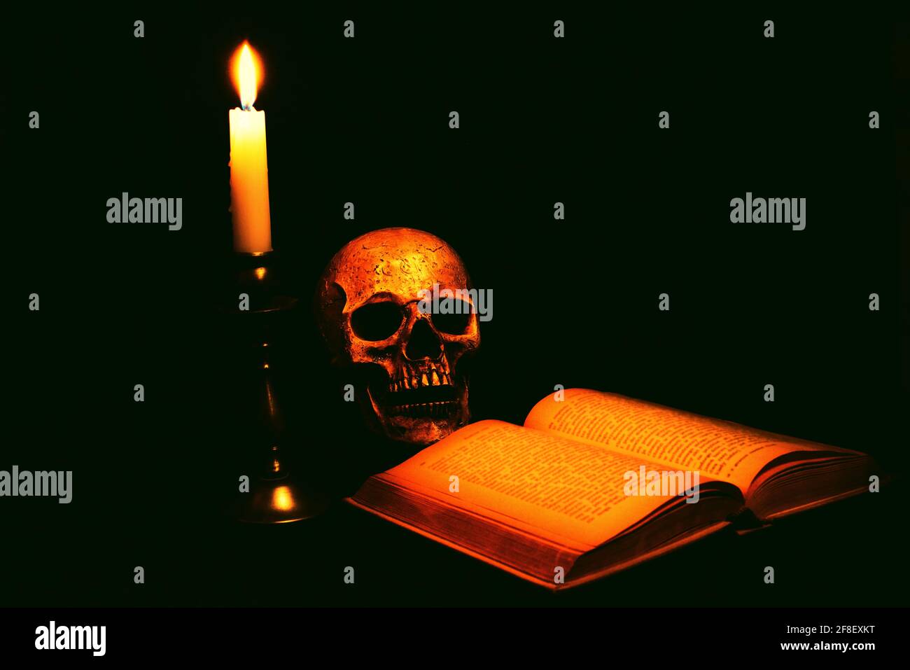 A skull, book and a candle Stock Photo - Alamy