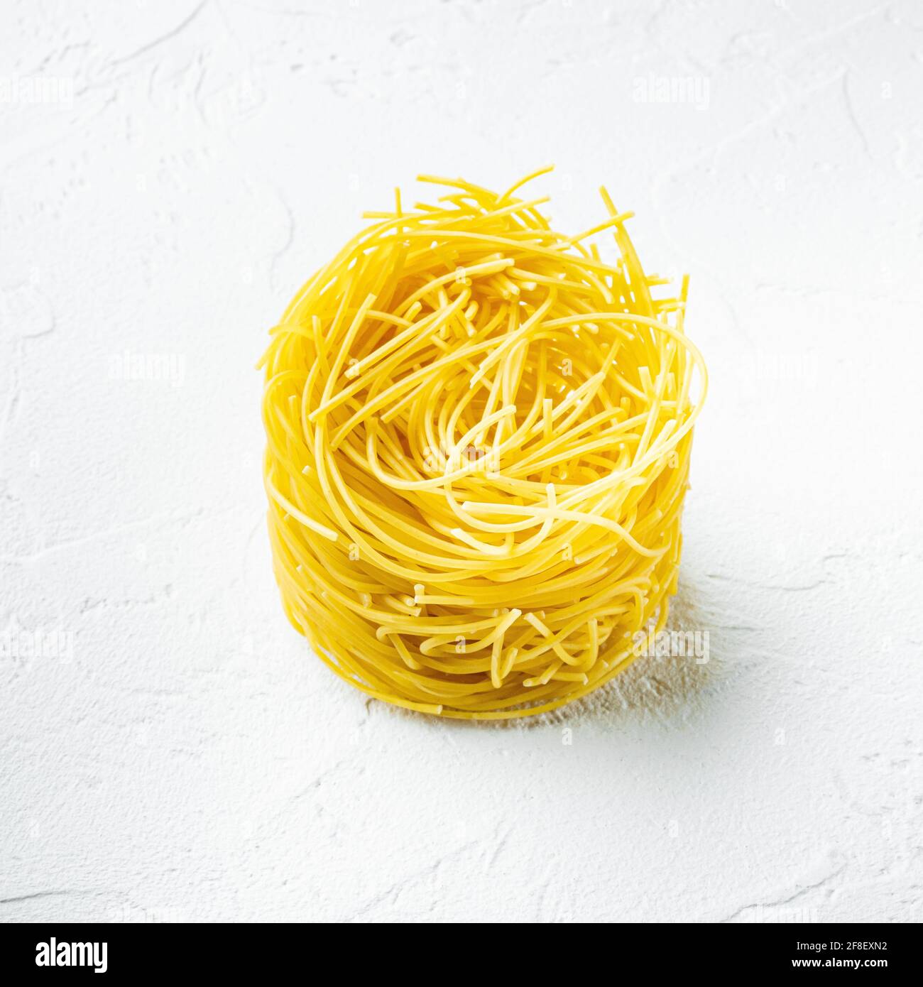 Dried taglierini set, on white stone surface, square format Stock Photo ...