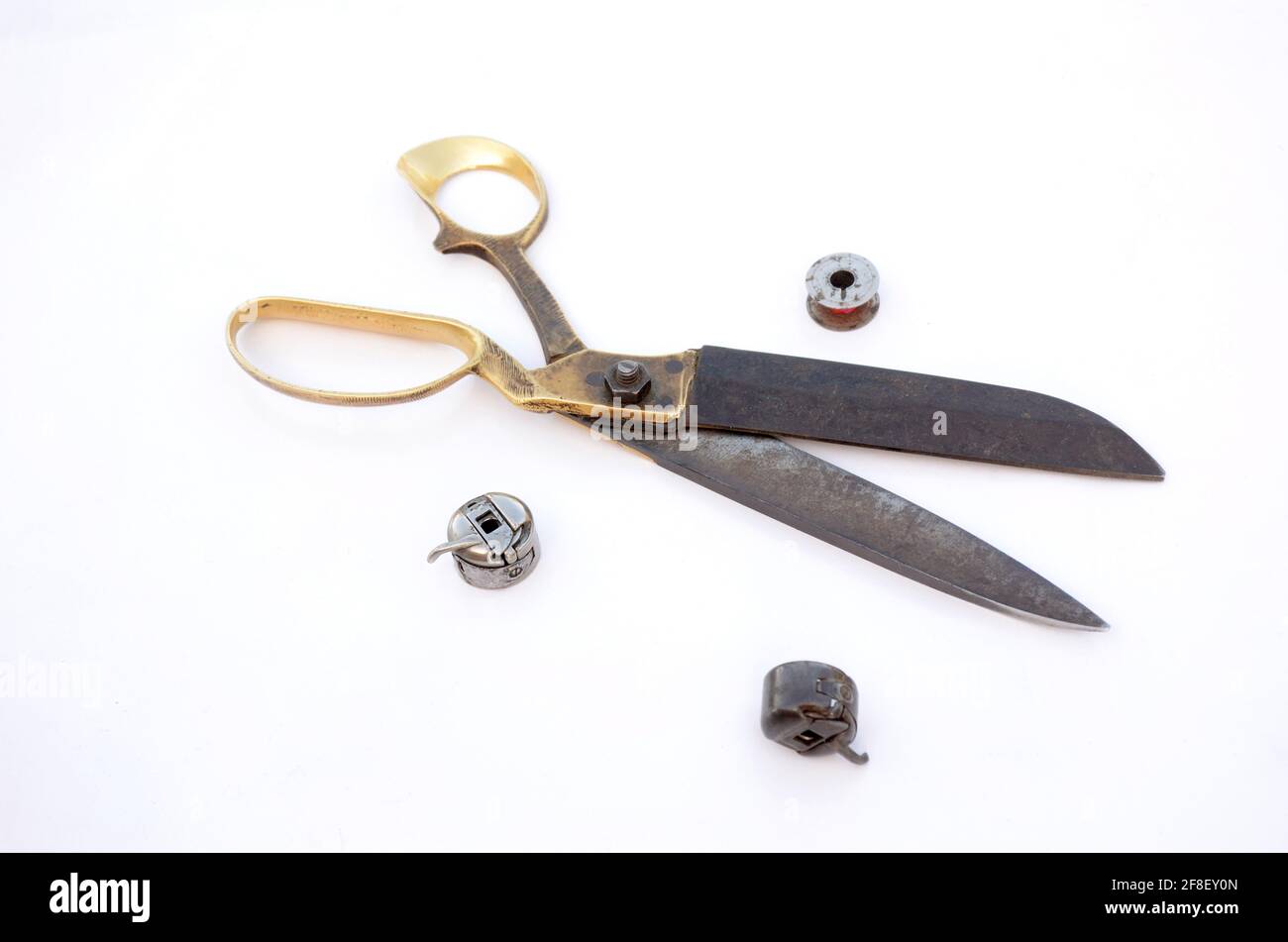 Metal brass scissors with metal bobbins isolated on white background ...