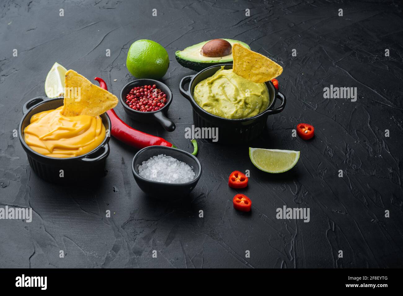 Green guacamole and yellow cheese dip sauce for traditional, Mexican ...