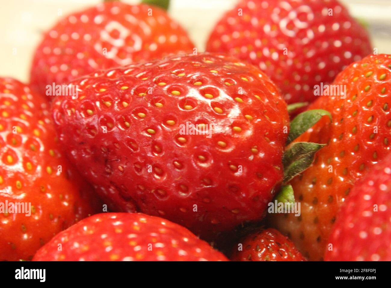 A group of strawberries on display Stock Photo - Alamy